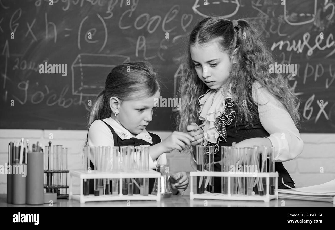Kids busy with experiment. Test tubes with colorful substances ...