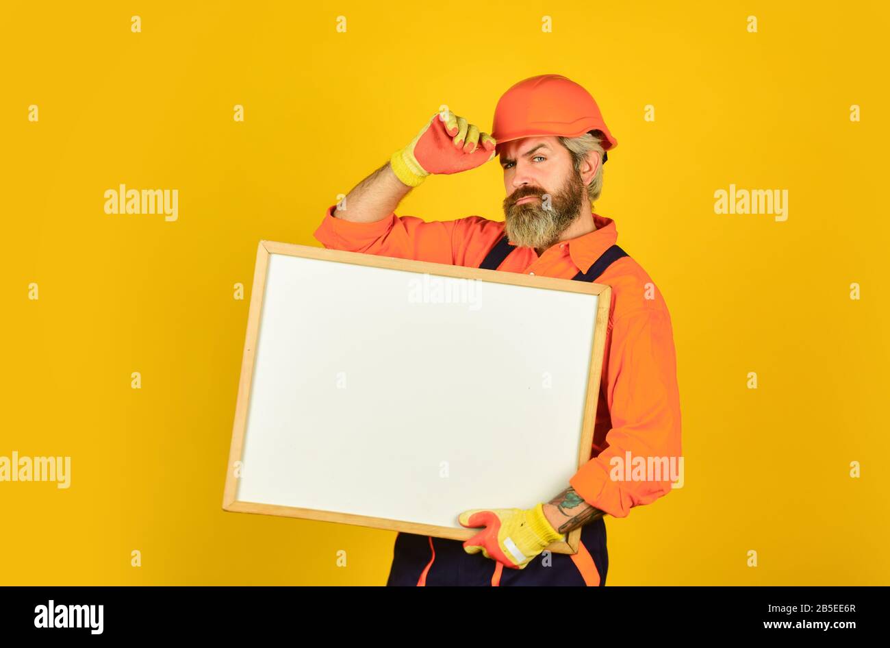 Serious Builder man with flipchart. Engineer project, copy space ...