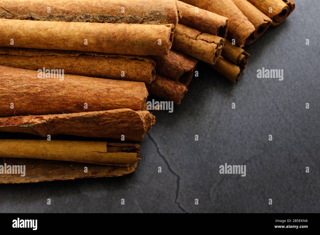 dry Cinnamon sticks isolated on black ground Stock Photo - Alamy