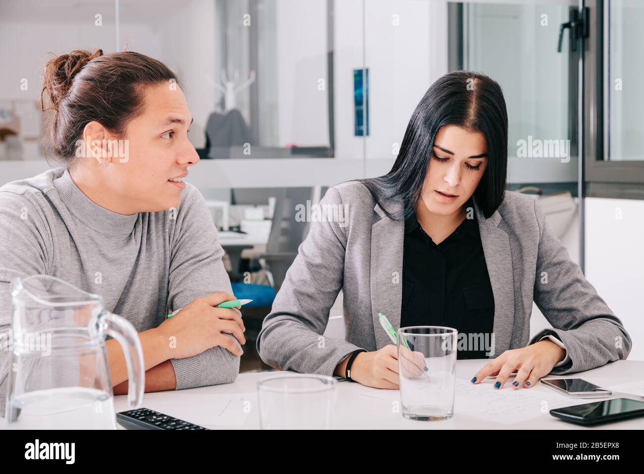 Group of office workers at a meeting around the boss Stock Photo - Alamy