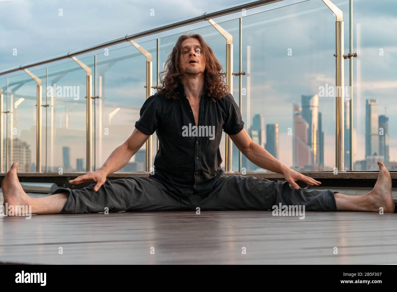 Athletic Sporty Man Doing Straddle Splits Outdoors On Urban Background ...