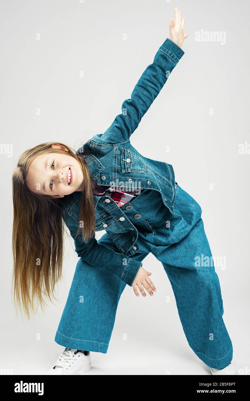 baby in motion. kids fashion little girl makes movement with her arms ...