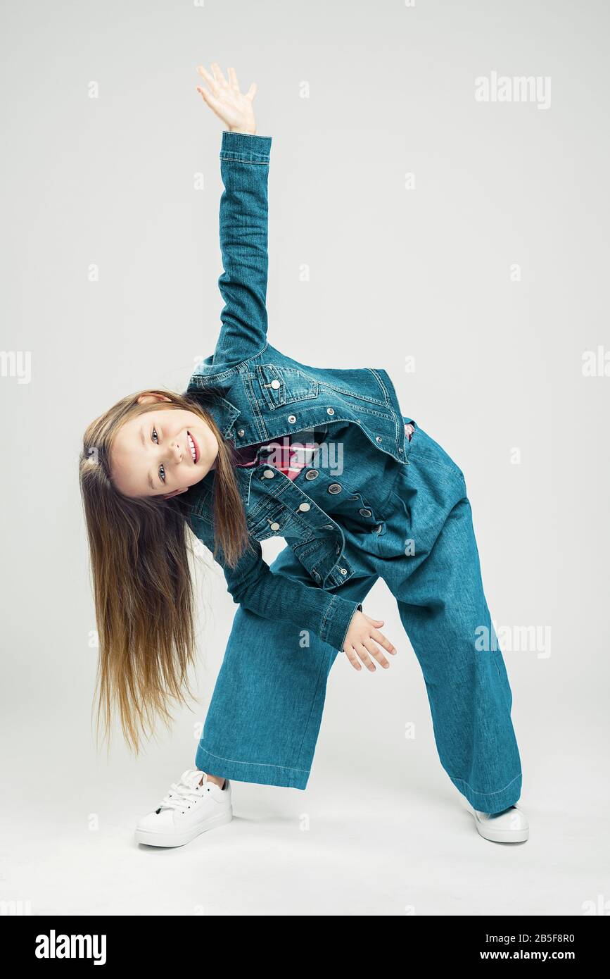 baby in motion. kids fashion little girl makes movement with her arms ...