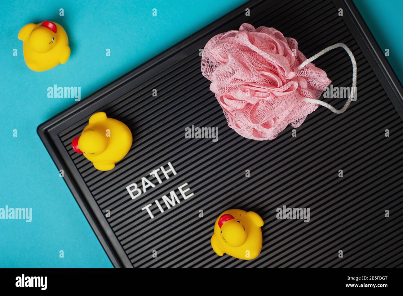 Bath time - text on black letter board with yellow rubber ducks and ...