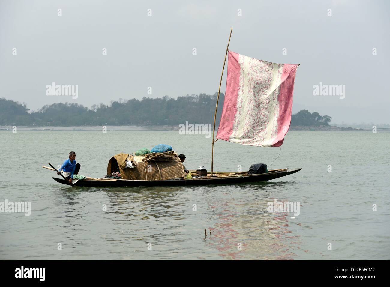 March 8, 2020, Guwahati, Assam, India: Fishermen on his boat in the ...