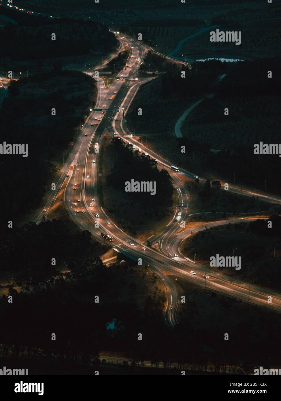 Some lit up roads at an intersection at night in Canberra, Australia ...