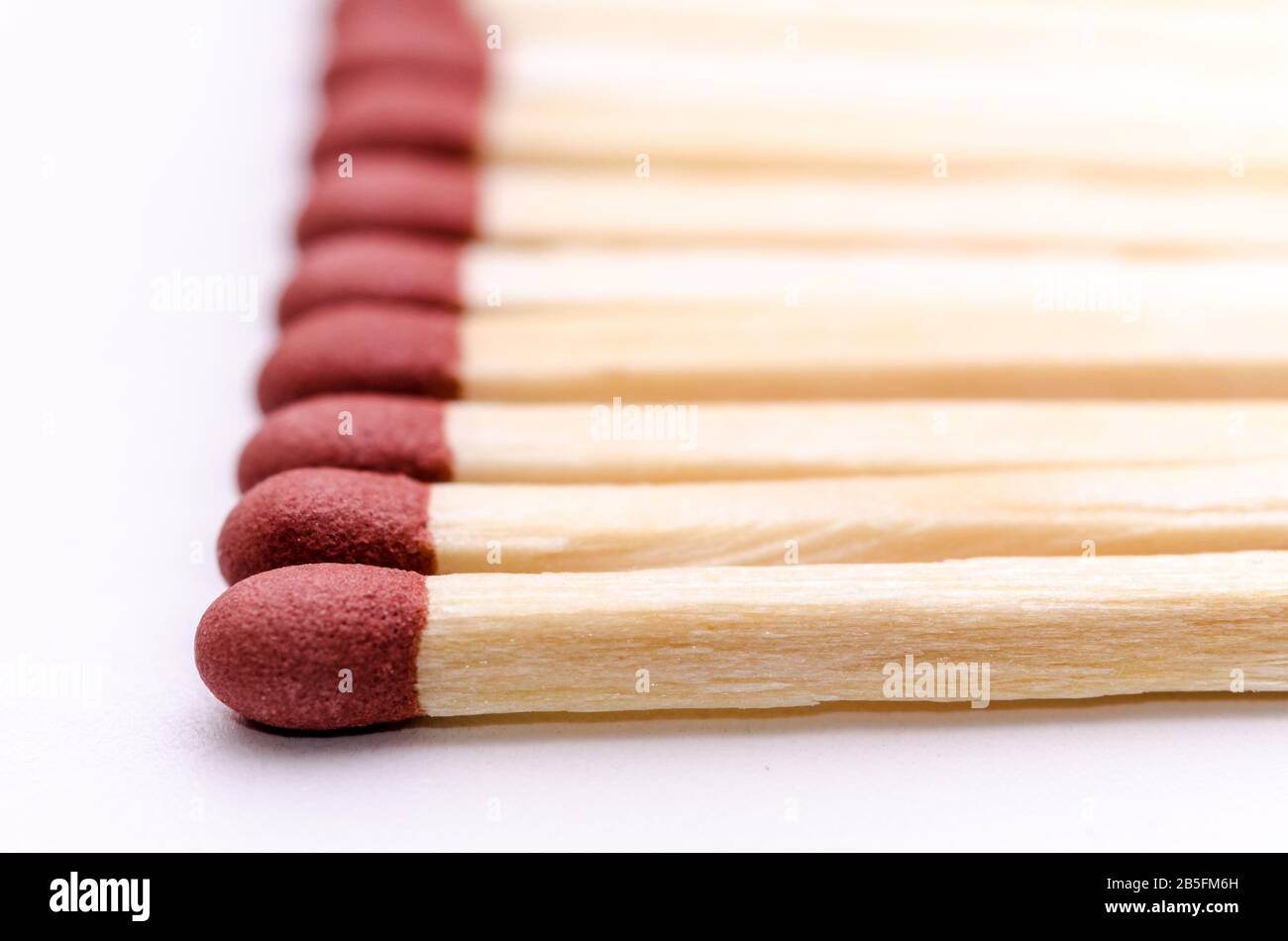 Matchsticks, close up macro of red matchstick heads against white ...