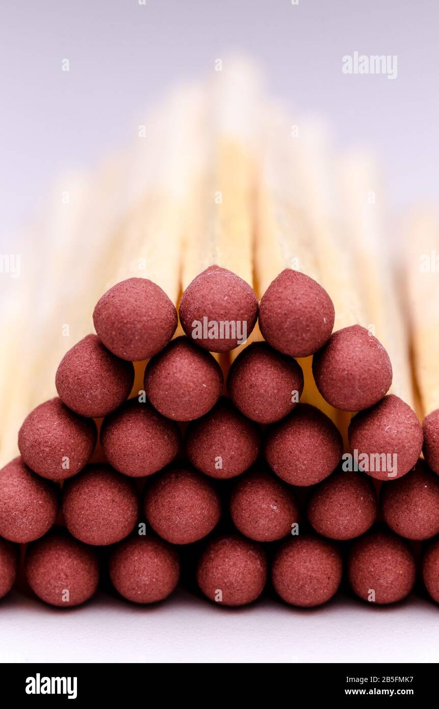 Matchsticks, close up macro of red matchstick heads against white ...