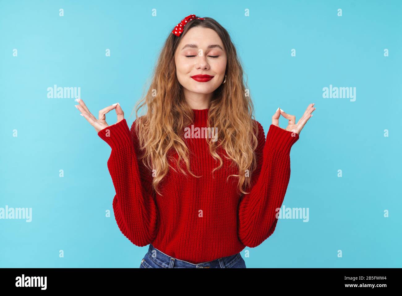 Image of calm caucasian woman in headband meditating with zen fingers ...