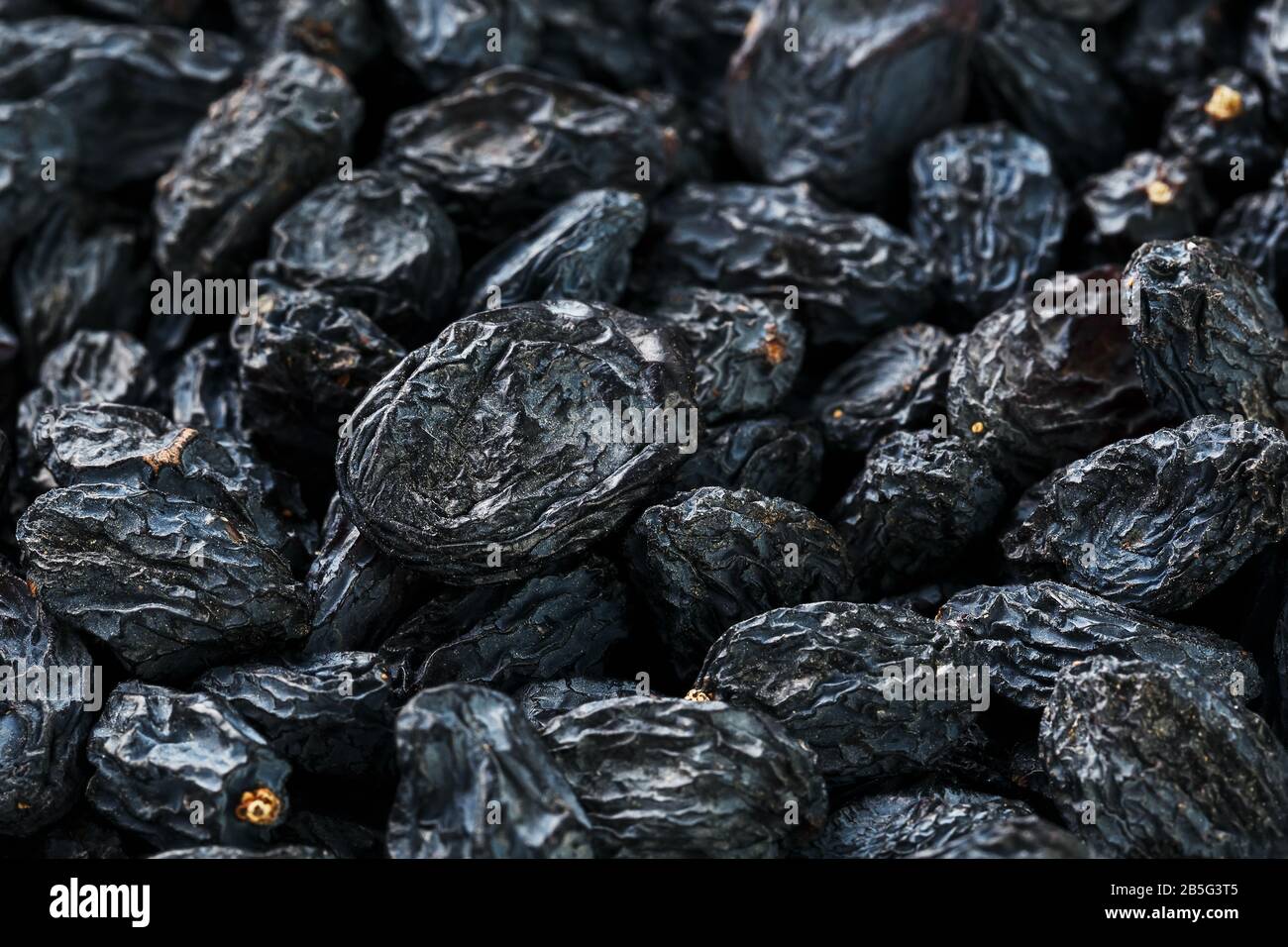 Black Raisin texture, popular dried fruit. Dried grapes. Red seedless ...
