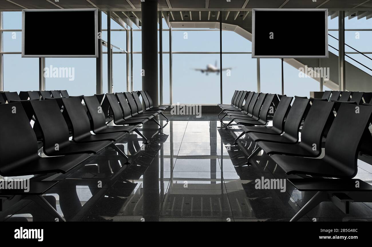 Rows of black chairs at airport and plane landing, There is a path for ...