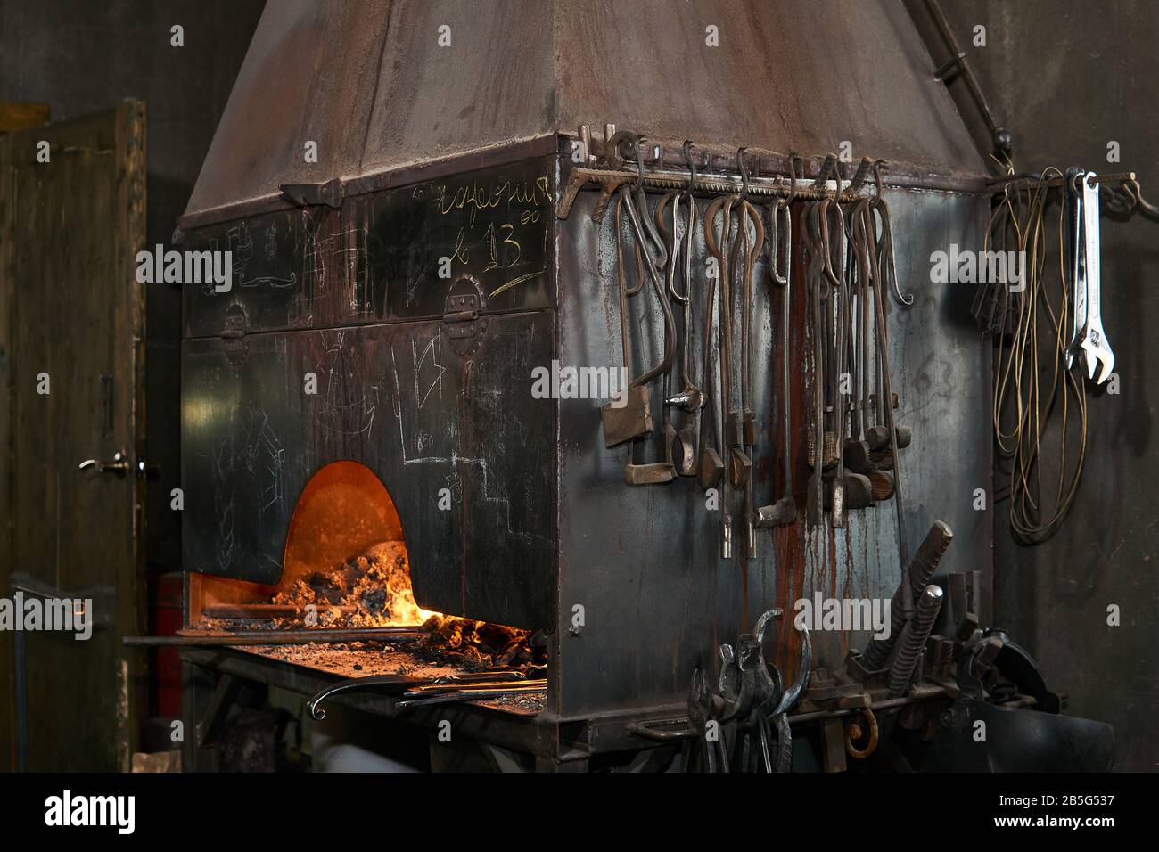 forge furnace with burning flame and blacksmith tools Stock Photo - Alamy
