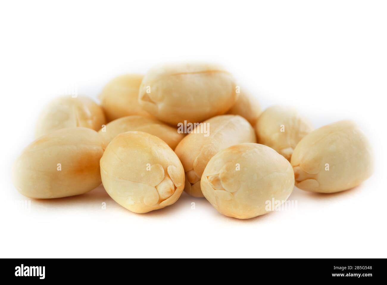 Roasted peanuts arranged peeled and isolated on a white background ...