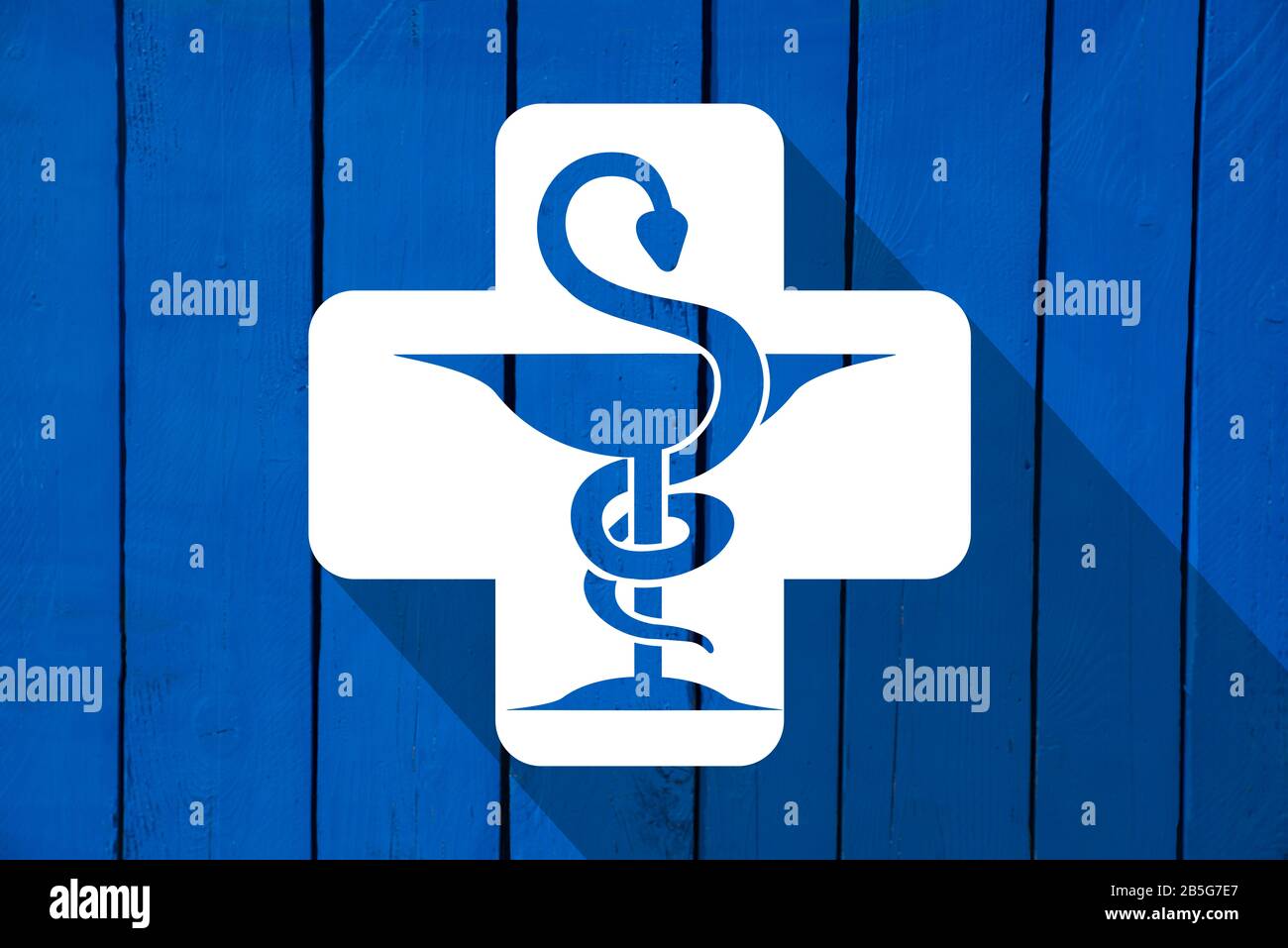 Pharmacy icon in a cross on wood background Stock Photo - Alamy