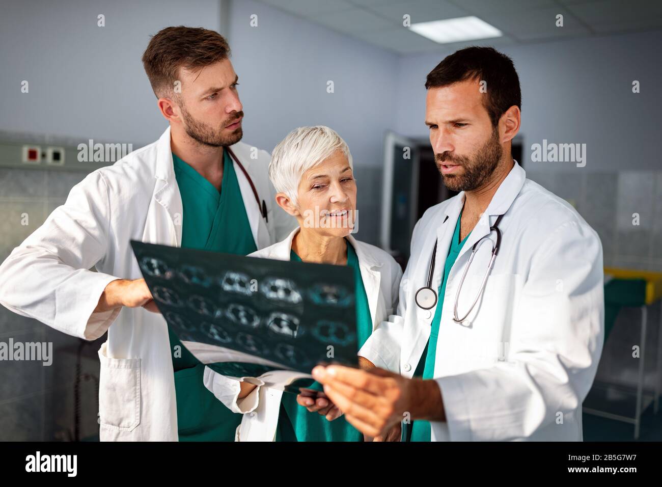 Doctors examining an x-ray report in hospital to make diagnosis Stock ...