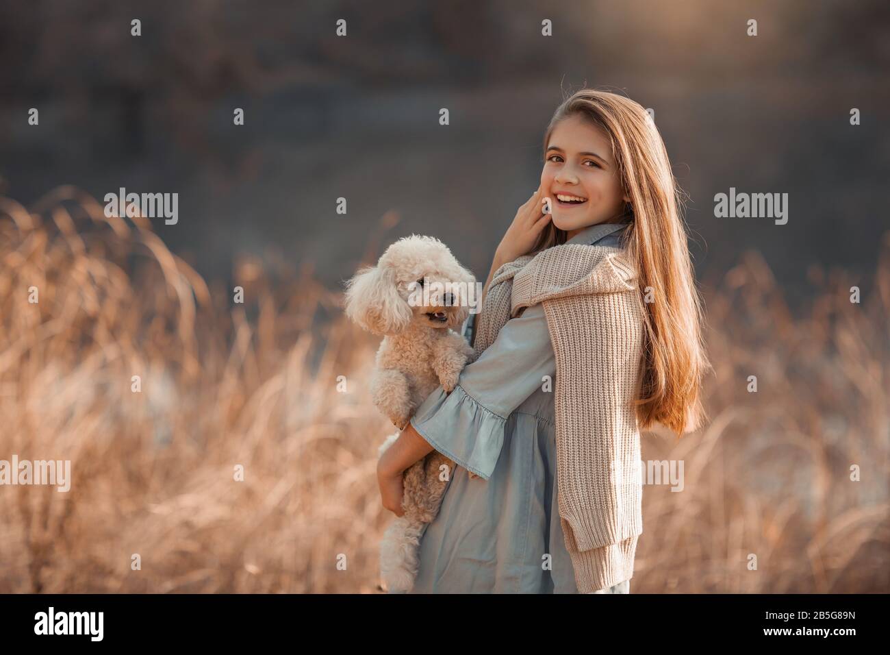 Woman holding poodle hi-res stock photography and images - Alamy