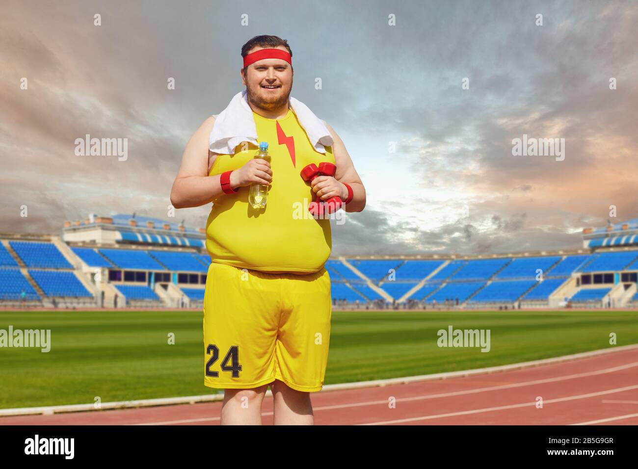 Fat man in yellow sportswear with dumbbells in his hands playing sports ...