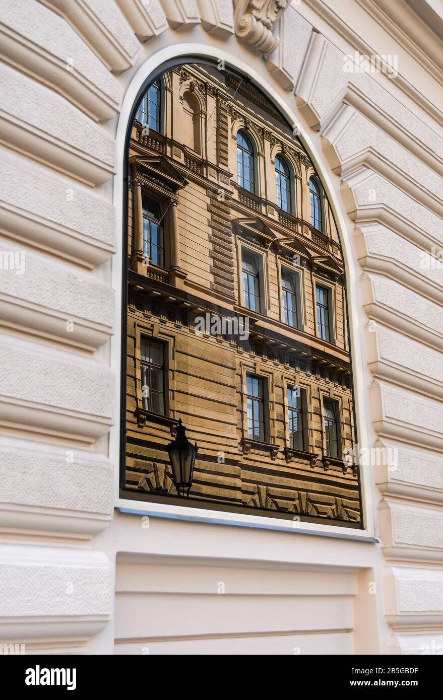 PRAGUE, CZECH REPUBLIC - JULY 2018: Old building reflected in one of ...