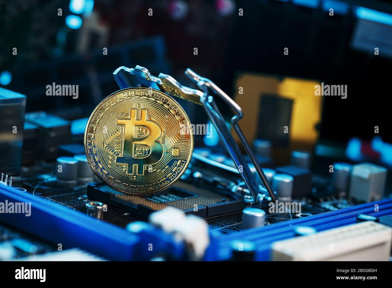 Golden Bitcoin Cryptocurrency on a computer board. Macro shooting. The ...