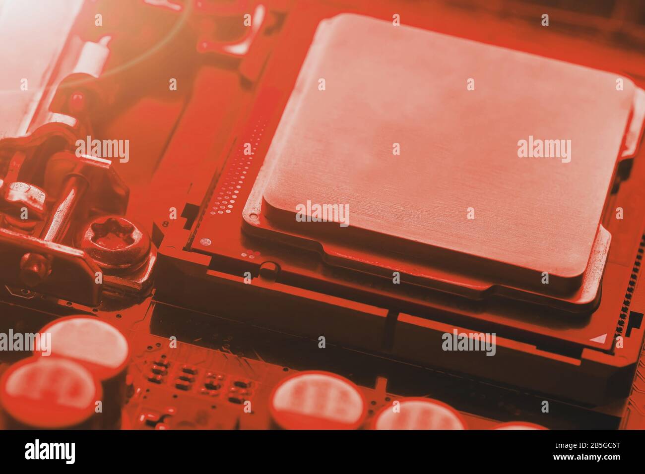 The central processor on the computer motherboard in red colors. PC ...