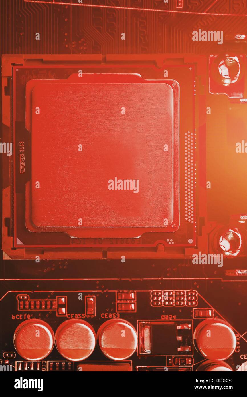 The central processor on the computer motherboard in red colors. PC ...
