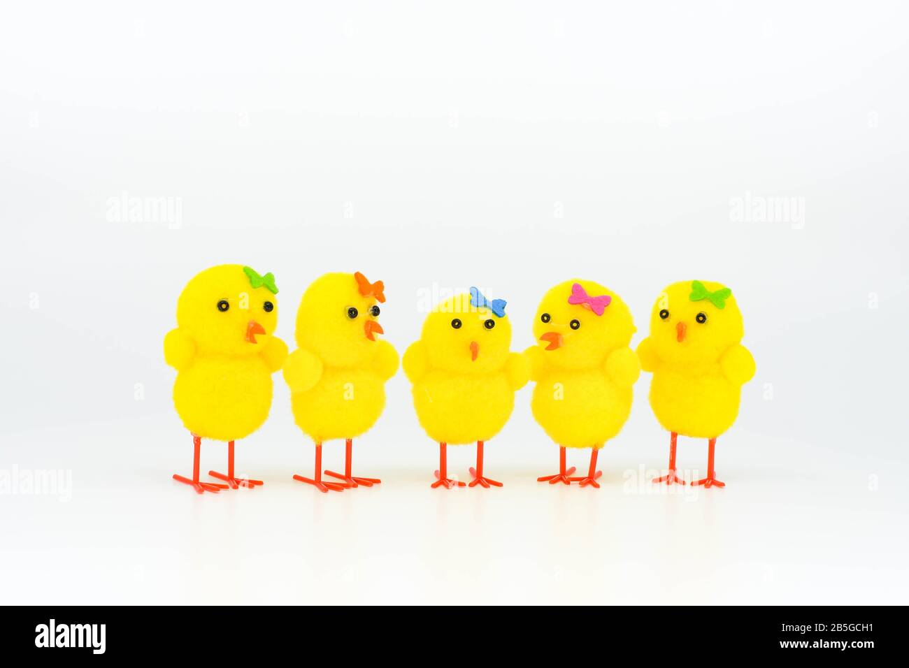 Group of cute yellow model chicks made of foam standing in a group ...
