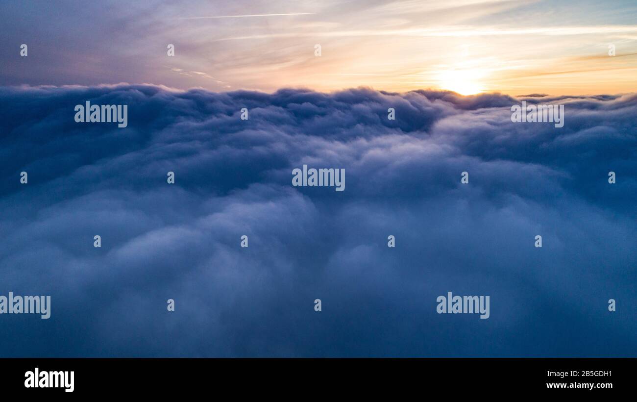 Magical view of blue cumulus clouds in winter at sunset. The concept of ...