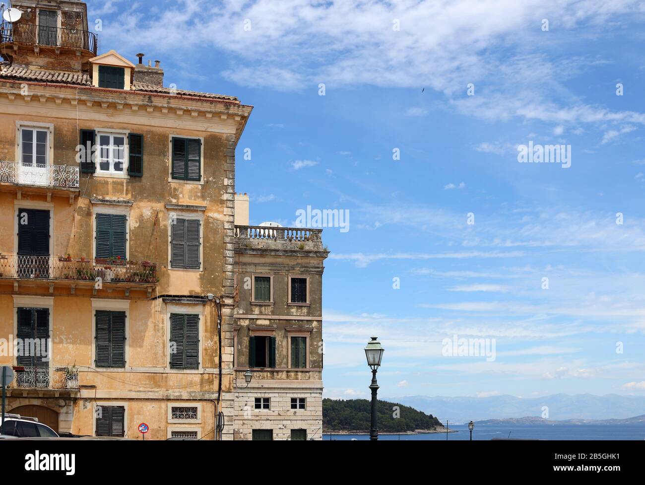 Old buildings sea and blue sky Corfu Greece Stock Photo - Alamy