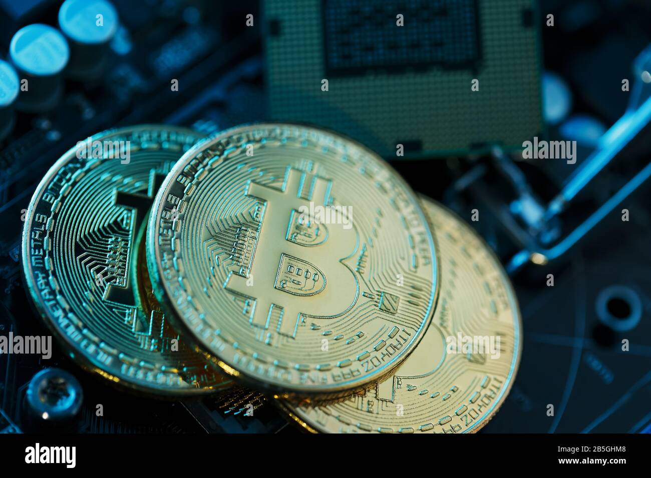 Golden Bitcoin Cryptocurrency on a computer board. Macro shooting. The ...