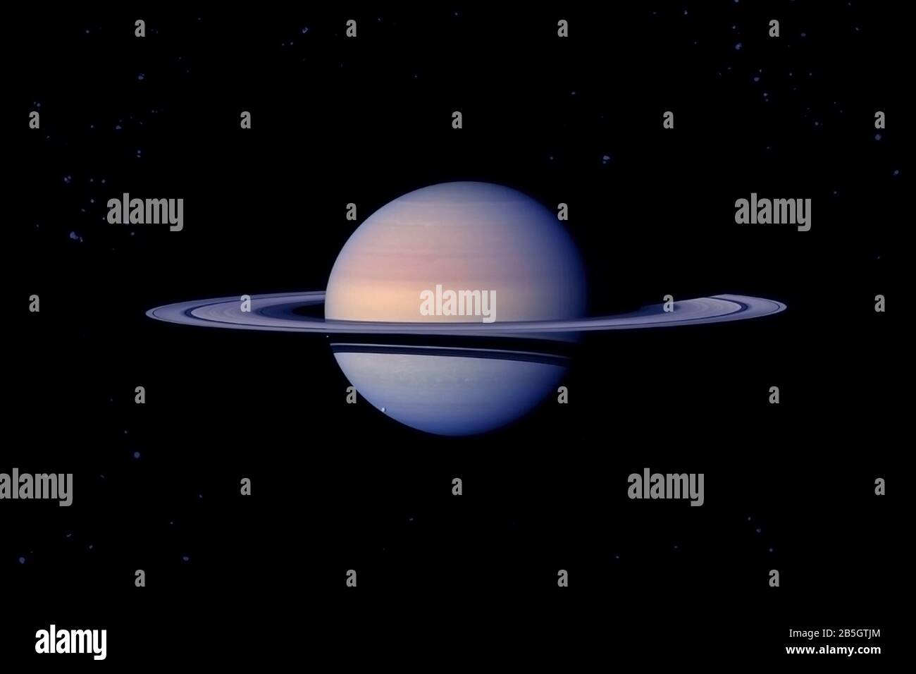 Saturn in unusual colors, on a dark background. Elements of this image ...