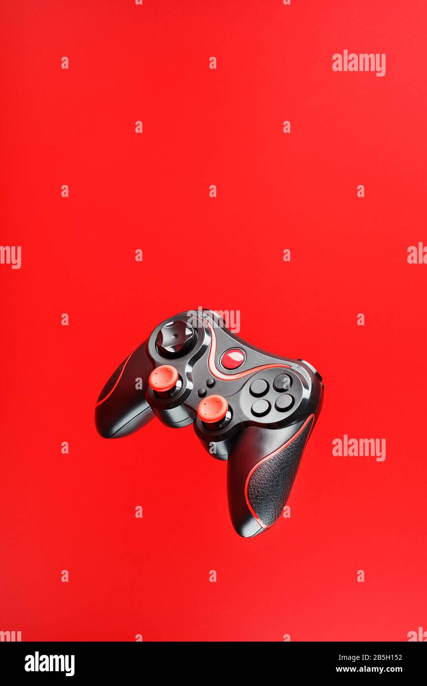 Game controller in flight on red background. Interactive entertainment ...