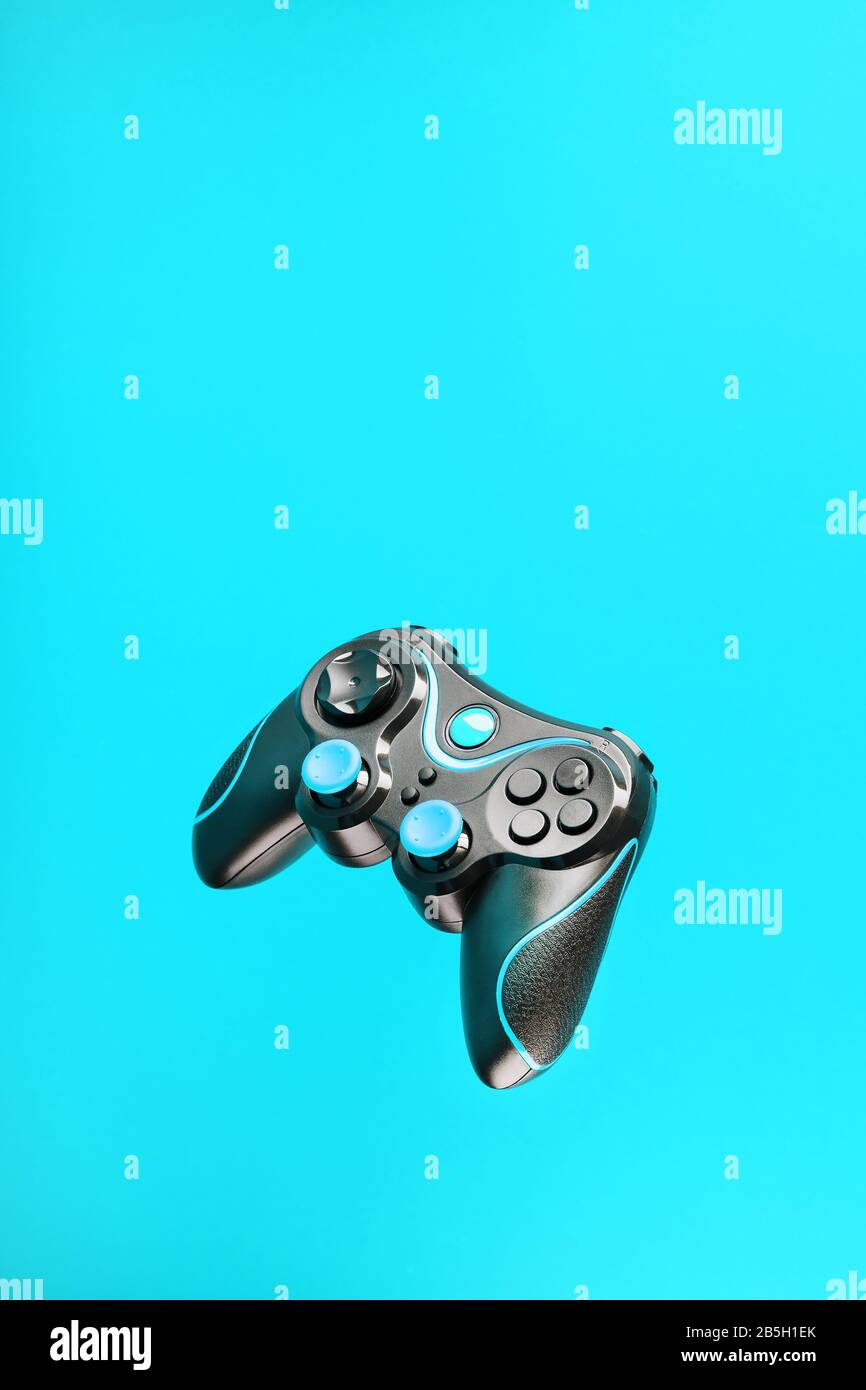 Game controller gamepad with blue buttons on cyanide background. Device ...