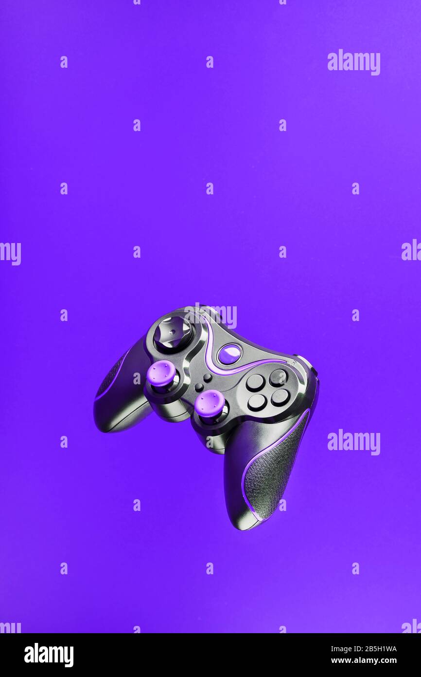 Game controller gamepad with pink buttons on lilac background. Device ...
