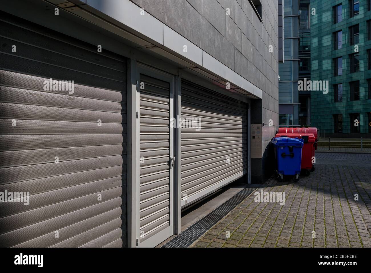 View of metal roller shutter doors and metal door at service area of ...