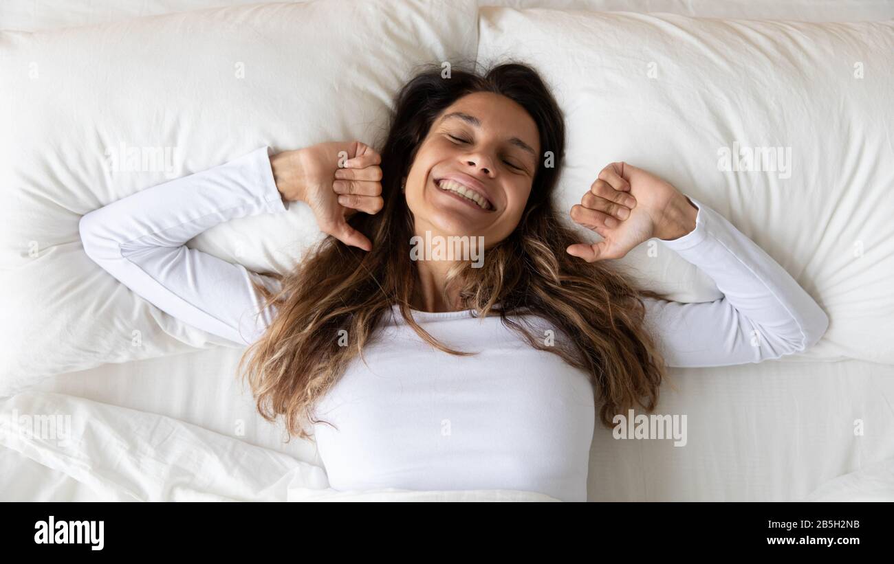 Happy girl stretching in bed waking up in morning Stock Photo - Alamy Happy girl stretching in bed waking up in morning Stock Photo - Alamy