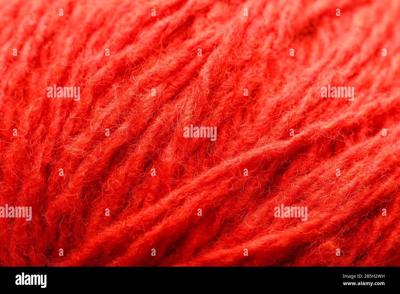 Wool yarn close-up colorful red thread for needlework in macro ...