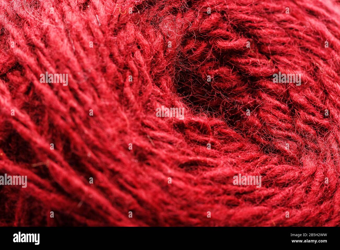 Wool yarn close-up colorful red thread for needlework in macro ...