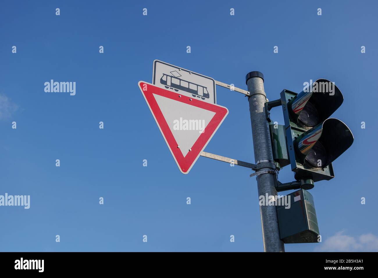 Low angle view of Caution and warning triangular sign with tram symbol ...