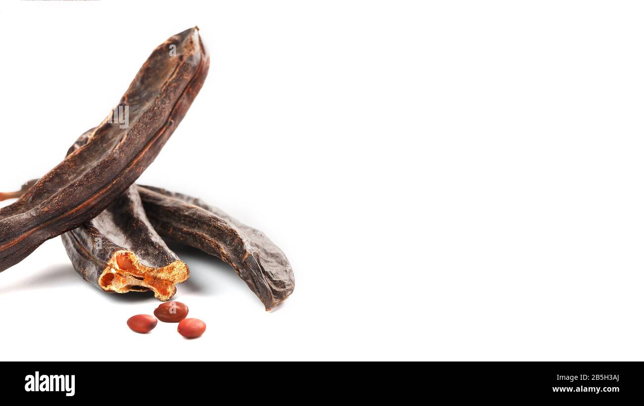 Carob carob fruit and seeds on white background. Isolate. Organic carob ...