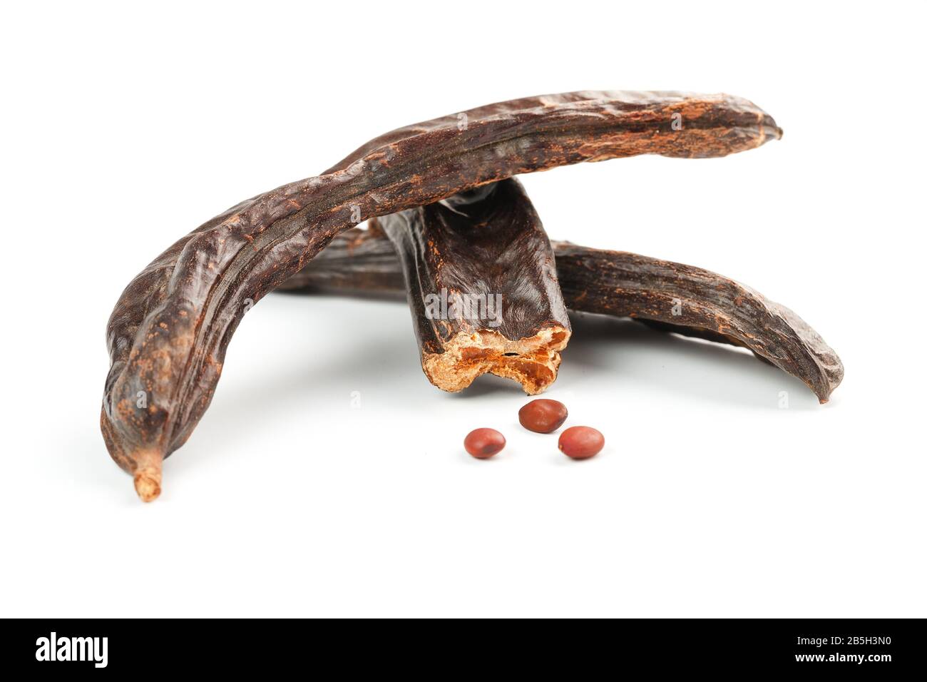 Carob carob fruit and seeds on white background. Isolate. Organic carob ...