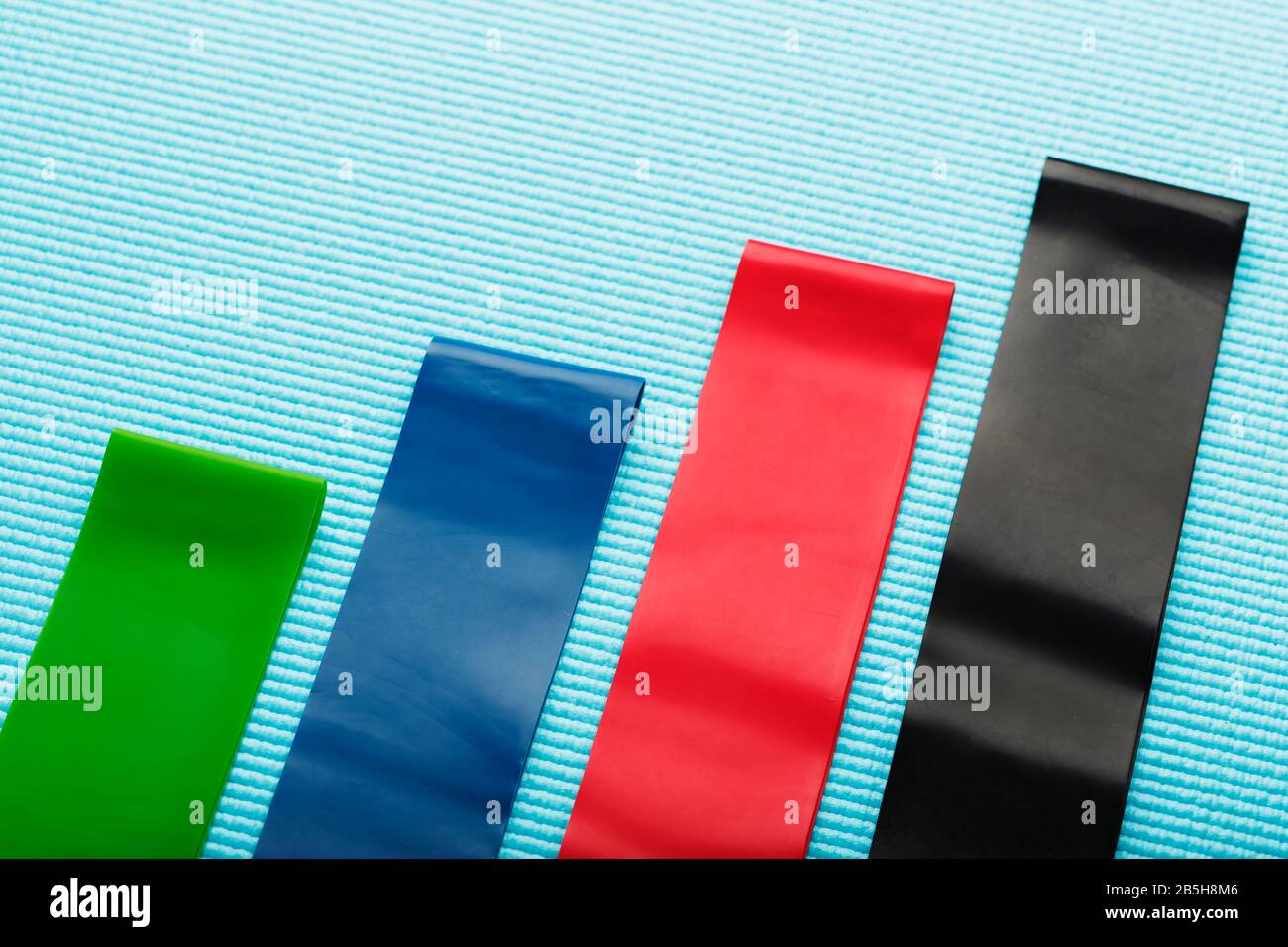 Fitness elastic bands of different colors and loads for sports on a ...