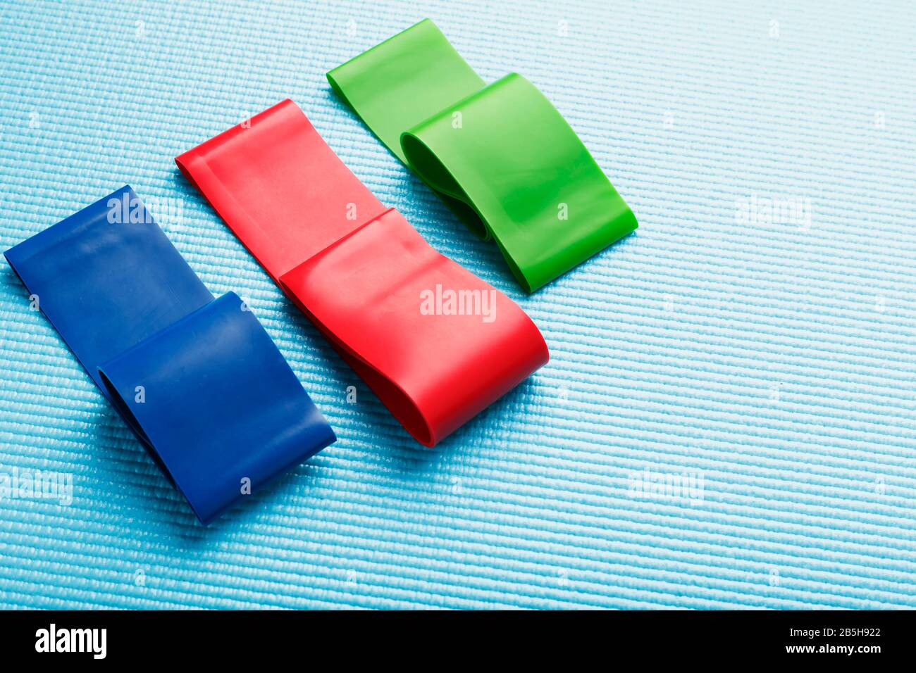 Fitness elastic bands of different colors and loads for sports on a ...