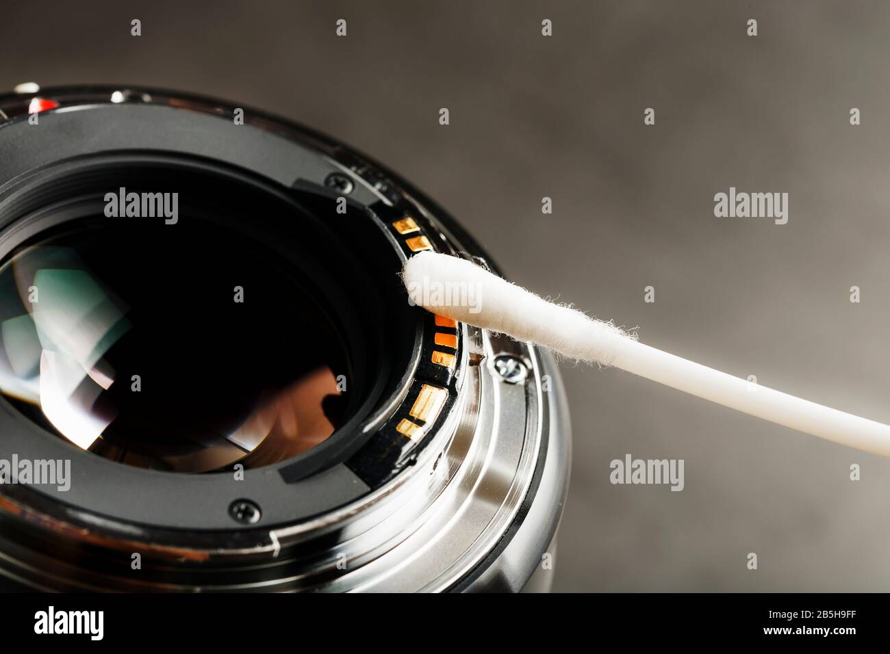 Gentle cleaning with a cotton swab camera Lens with a beautiful optical ...