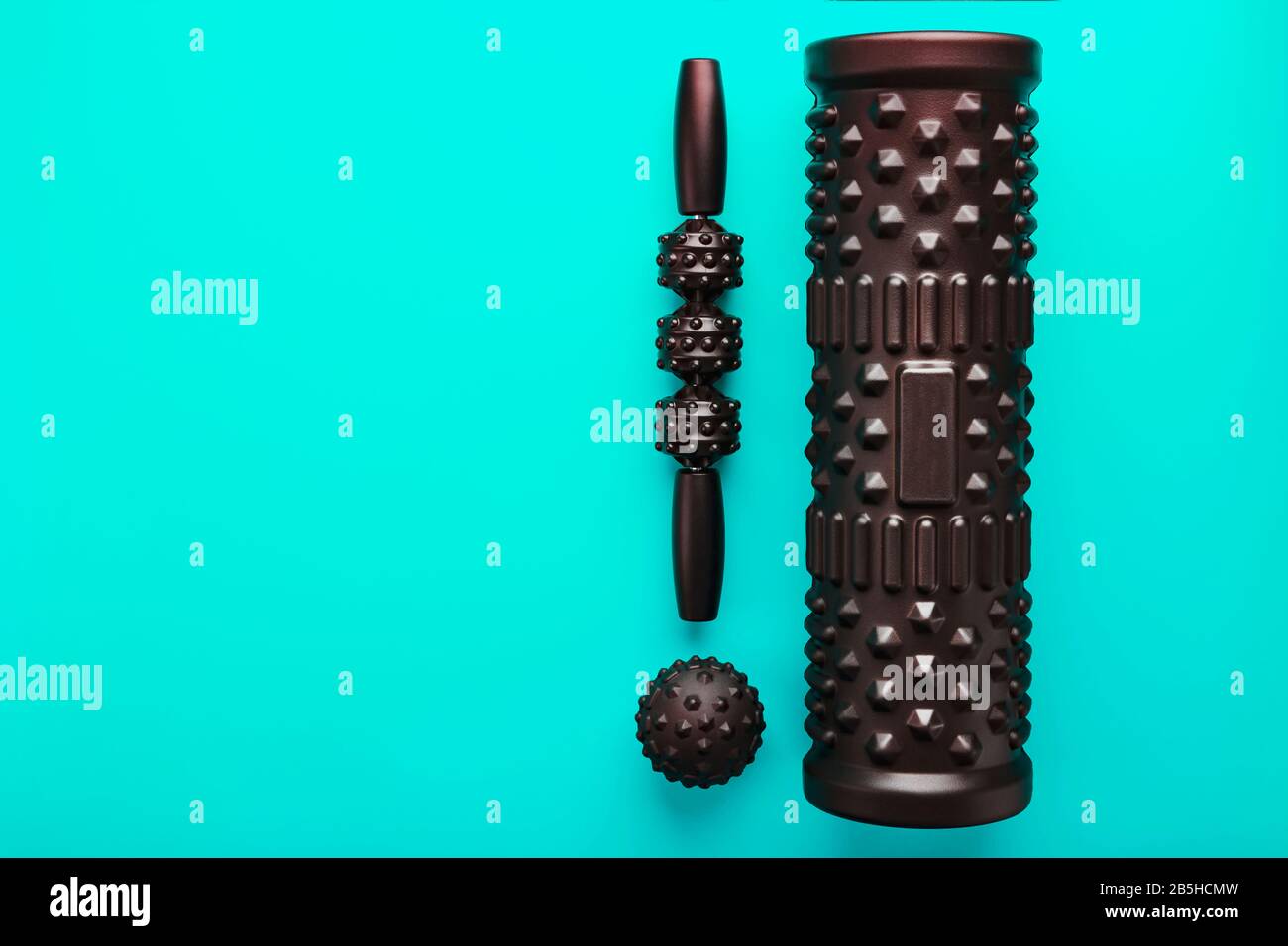 A set of black bumpy foam massage rollers, body rollers, rubber balls ...