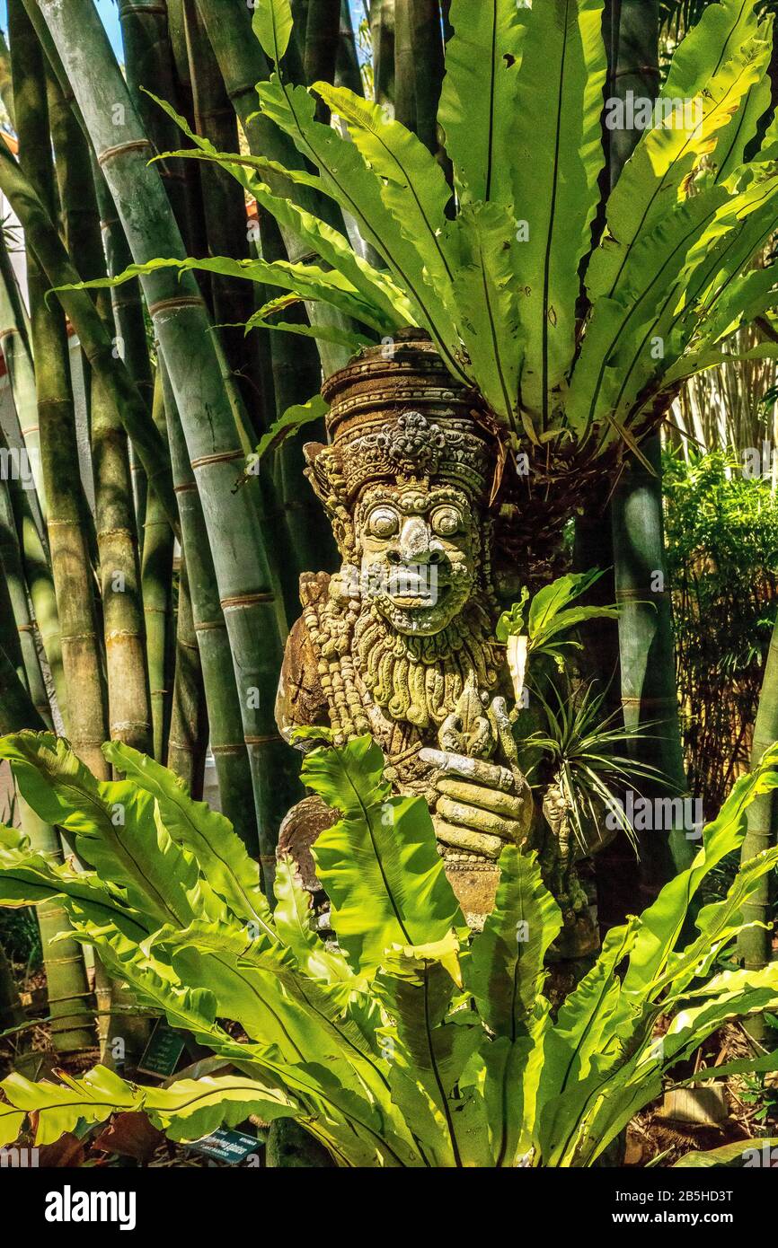 Statue of Hindu Temple Guardian in a tropical garden Stock Photo - Alamy