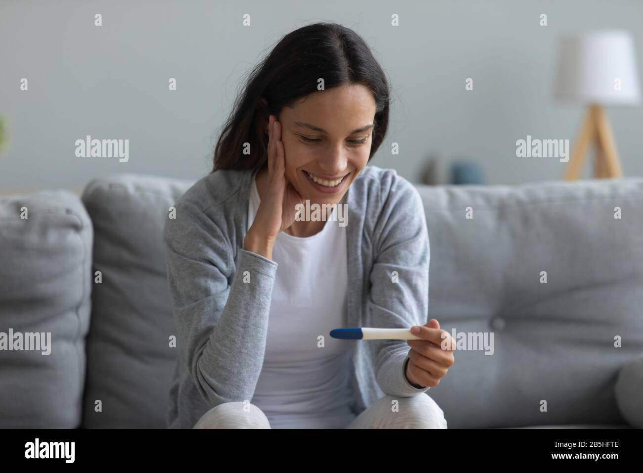 Happy young woman excited with positive pregnancy test result Stock ...