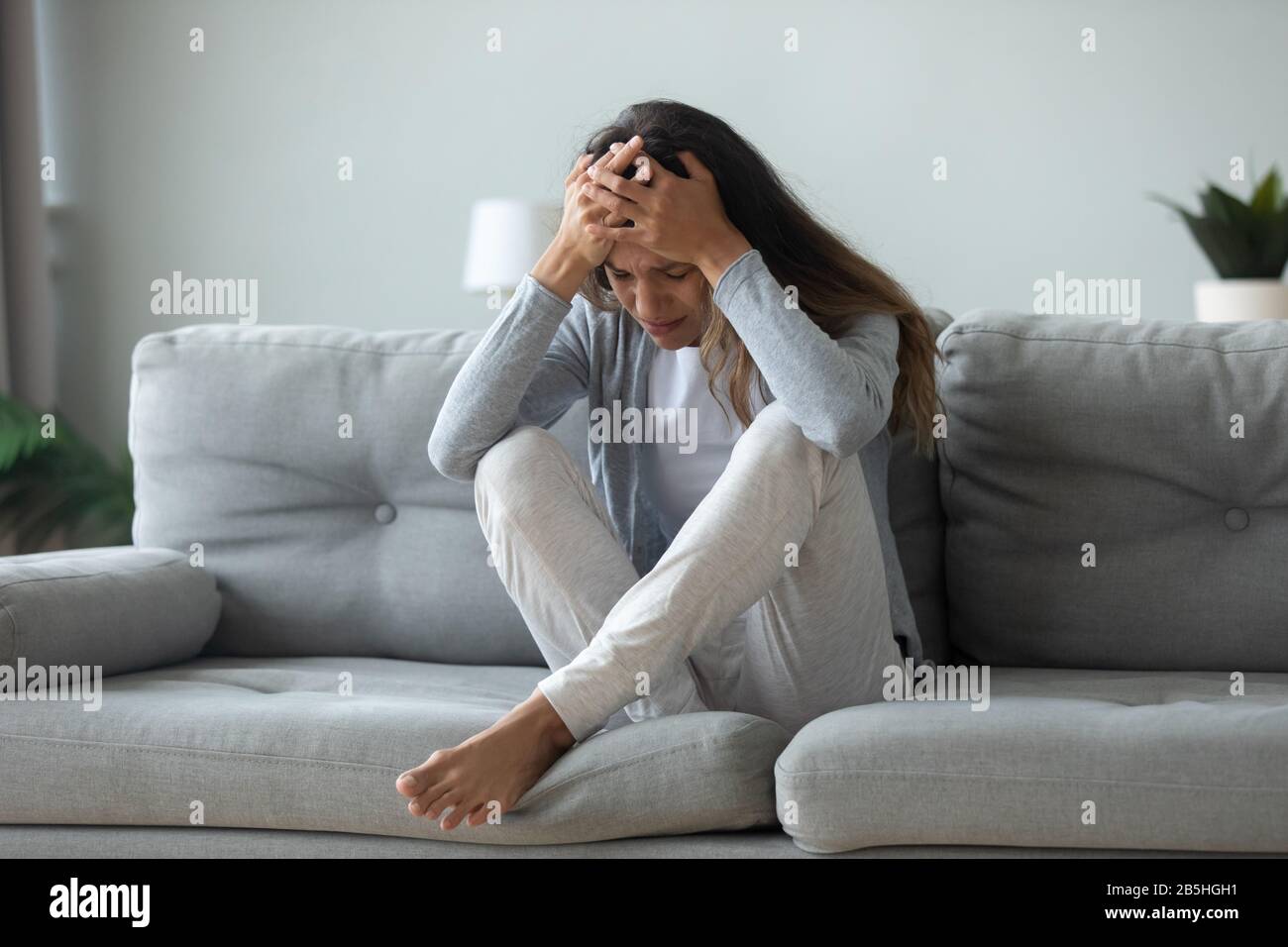 Depressed female crying suffer from depression at home Stock Photo - Alamy