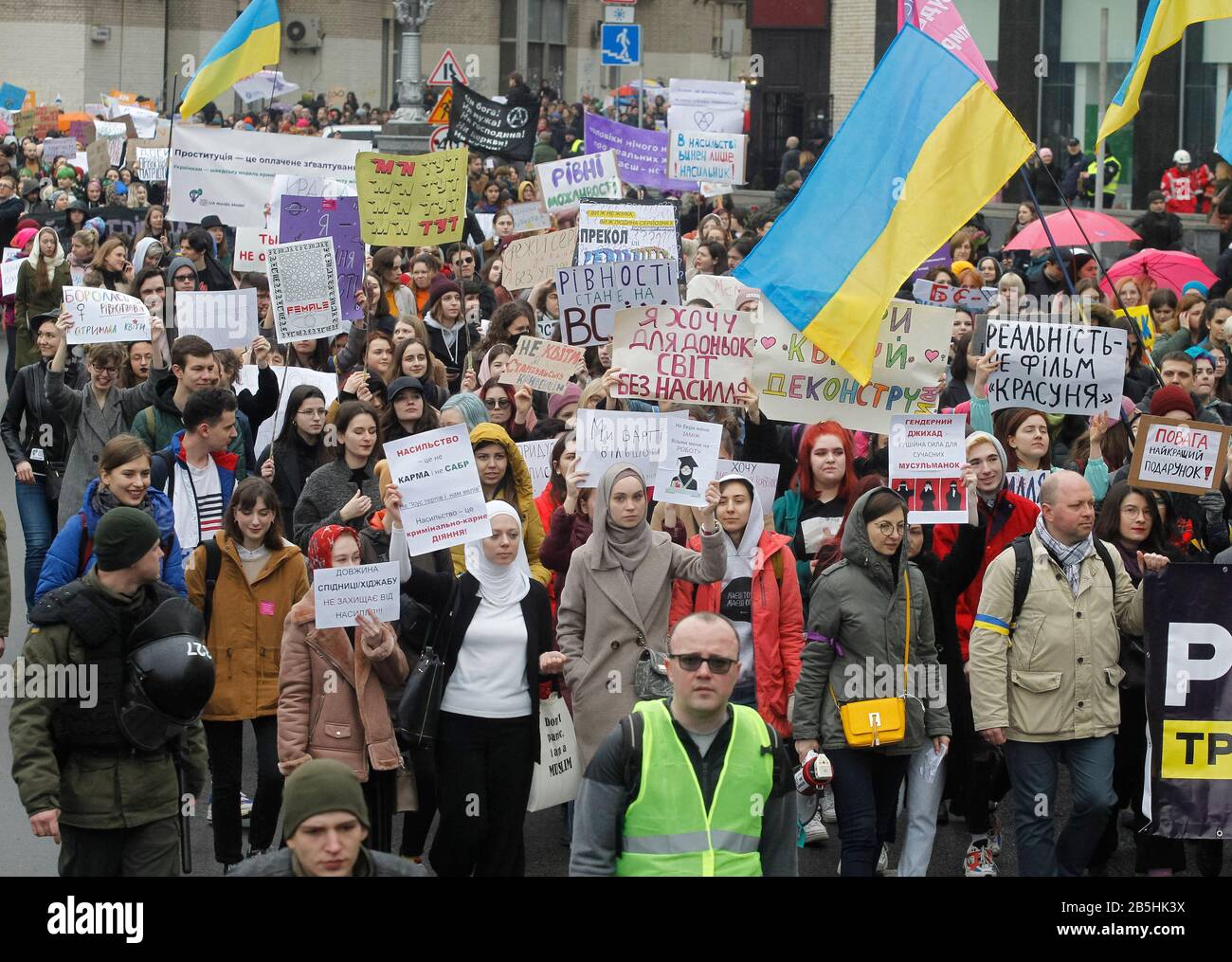 Activists marching with placards and flags during the march.Under the ...