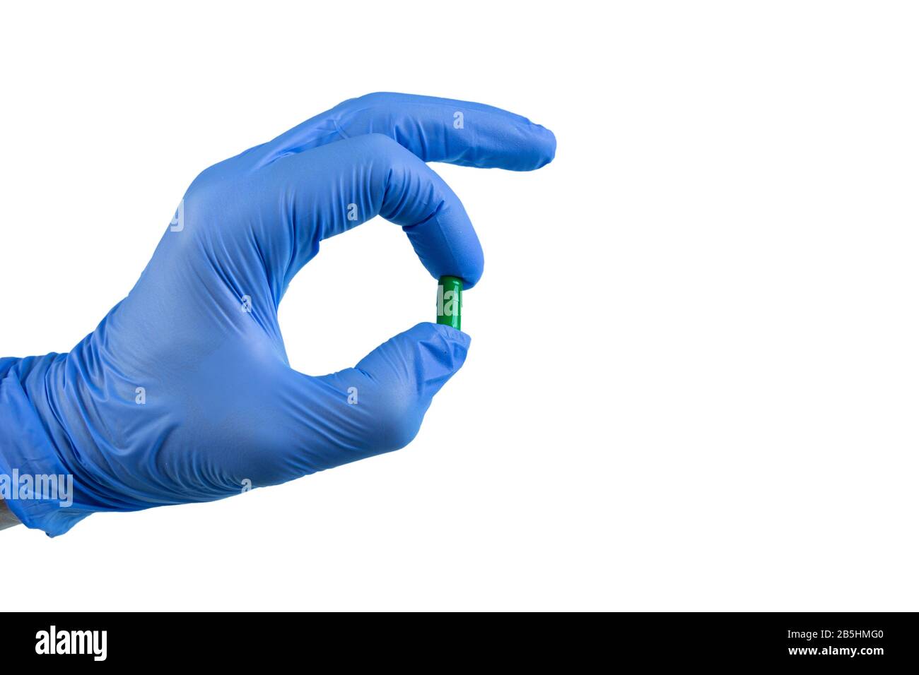 Tablets in the hand. Hands in medical gloves. Isolate. Medicines in the ...