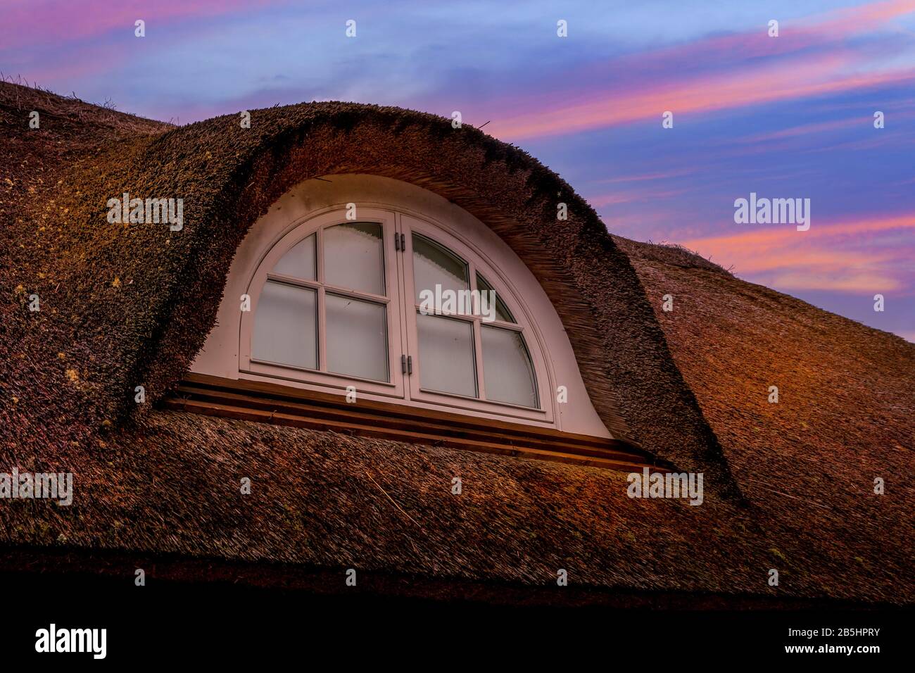 Nice thatched roof and vindow in sunset with a beautiful sky Stock ...